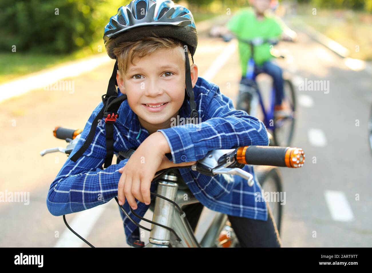 Cute boy riding bicycle outdoors Stock Photo - Alamy