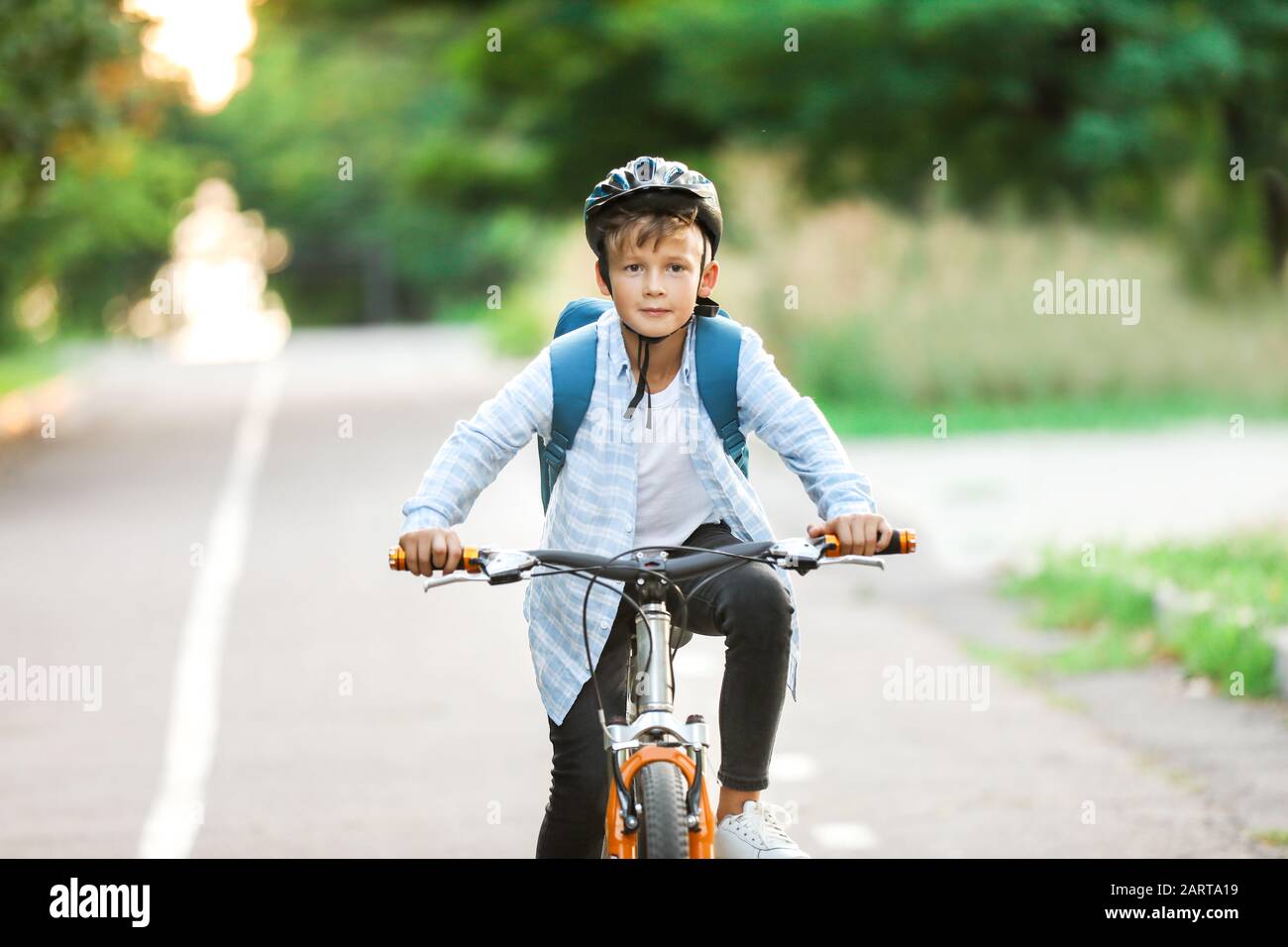 Cute boy riding bicycle outdoors Stock Photo - Alamy