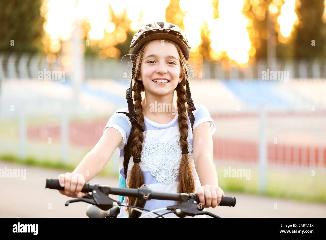 Cute girl riding bicycle outdoors Stock Photo - Alamy