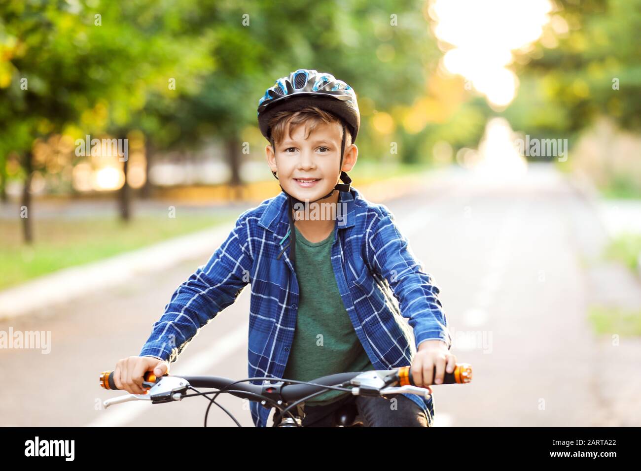 Cute boy riding bicycle outdoors Stock Photo - Alamy