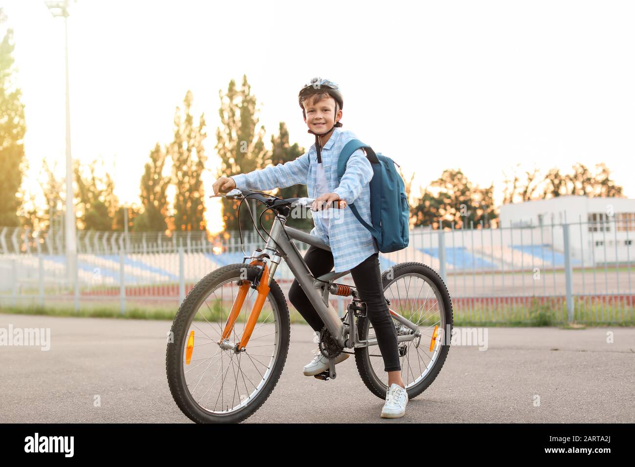 Cute boy riding bicycle outdoors Stock Photo - Alamy