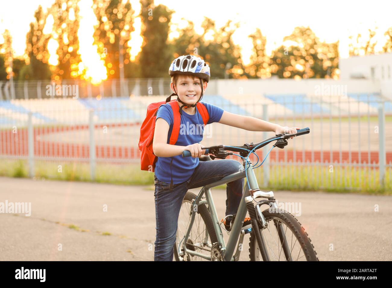 Cute boy riding bicycle outdoors Stock Photo - Alamy