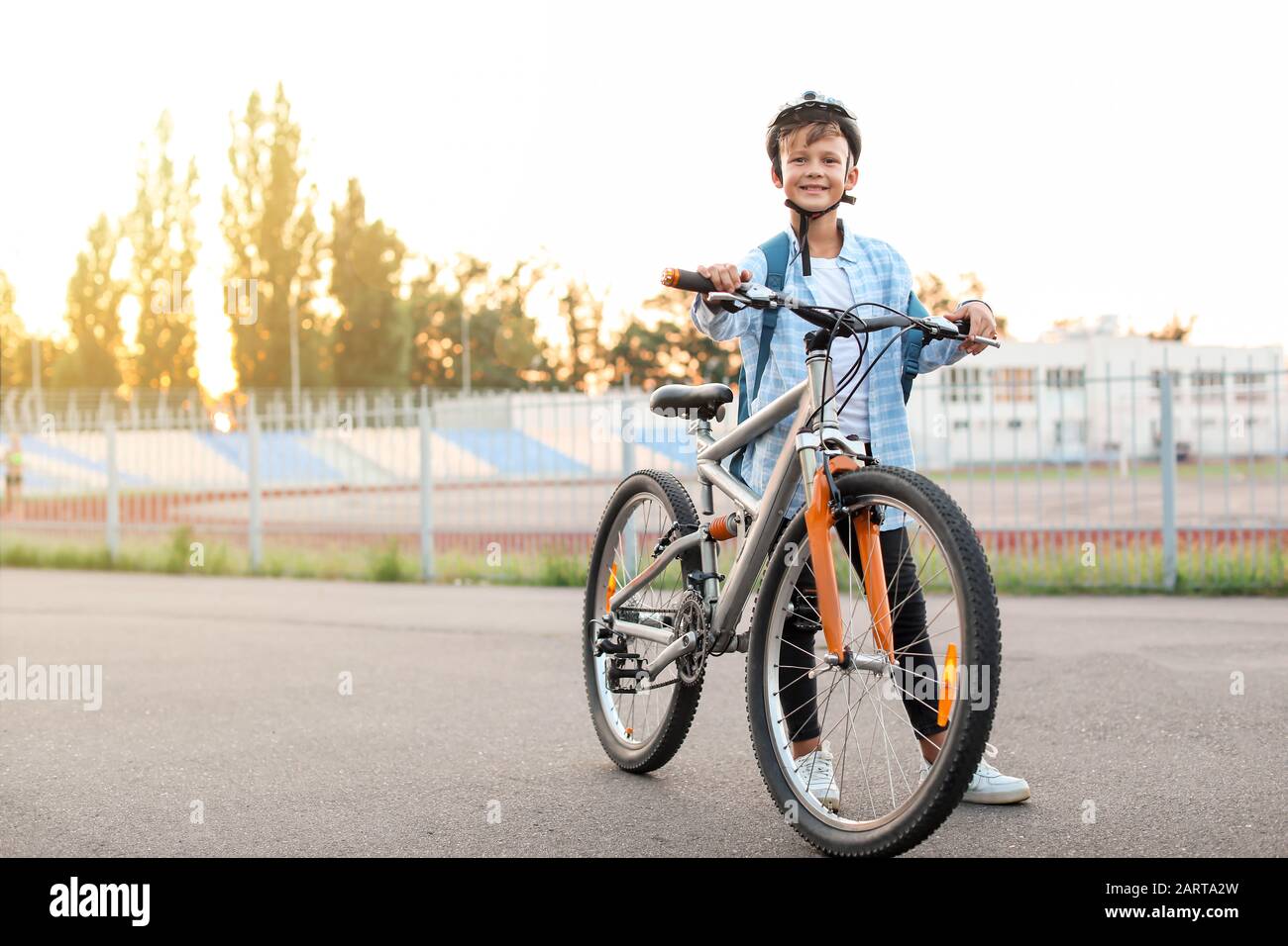 Cute boy riding bicycle outdoors Stock Photo - Alamy