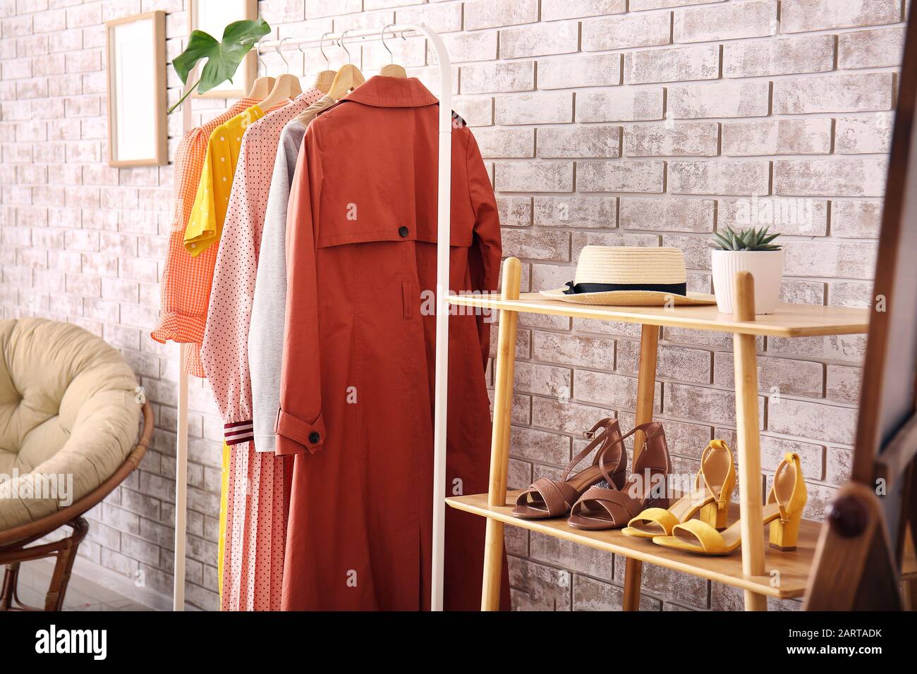 Rack with clean female clothes in dressing room Stock Photo - Alamy