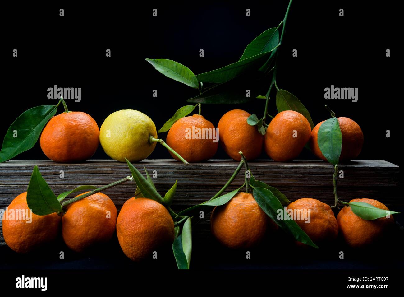 organic tangerines with leaves on black background Stock Photo - Alamy