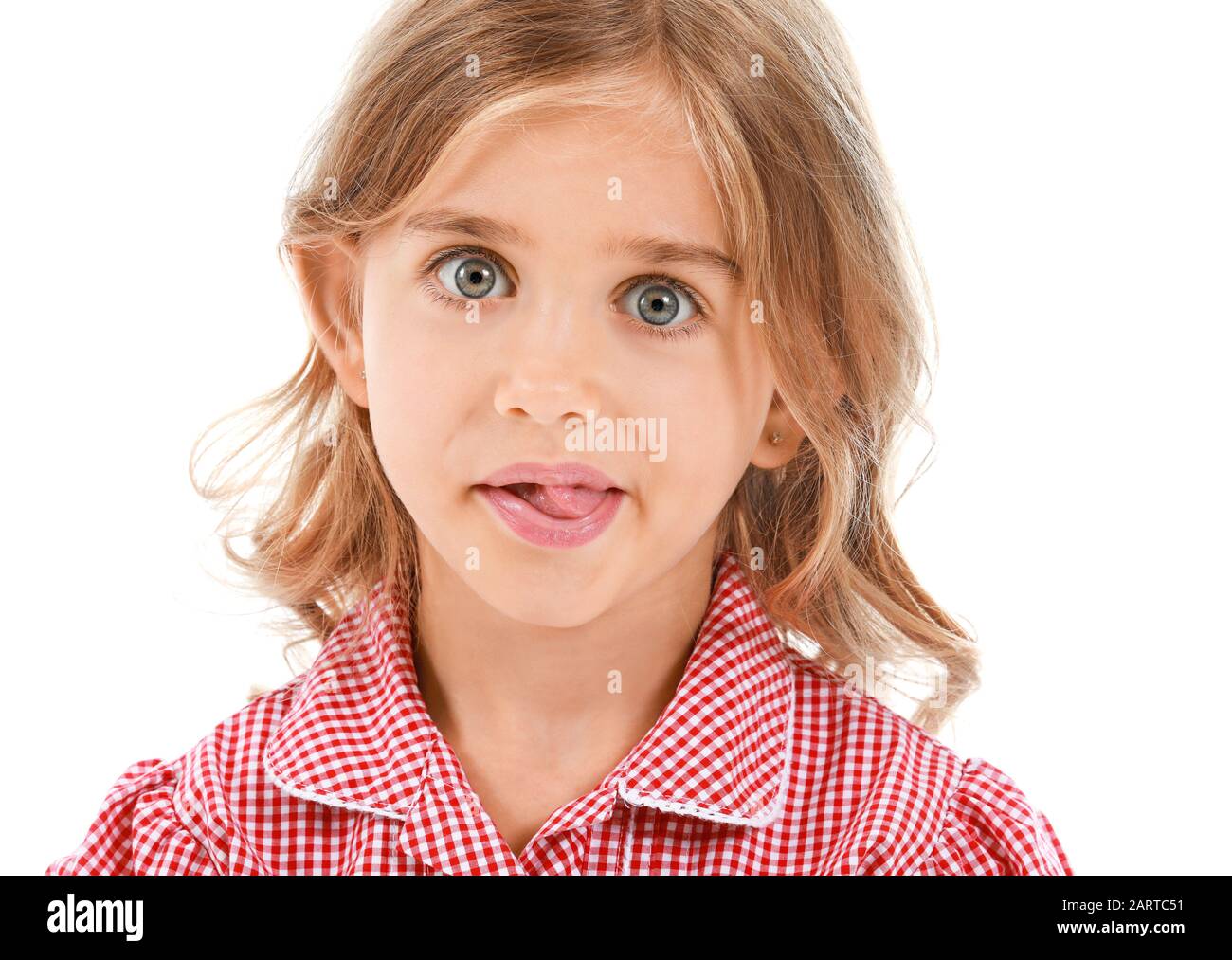 Grimacing little girl on white background Stock Photo - Alamy