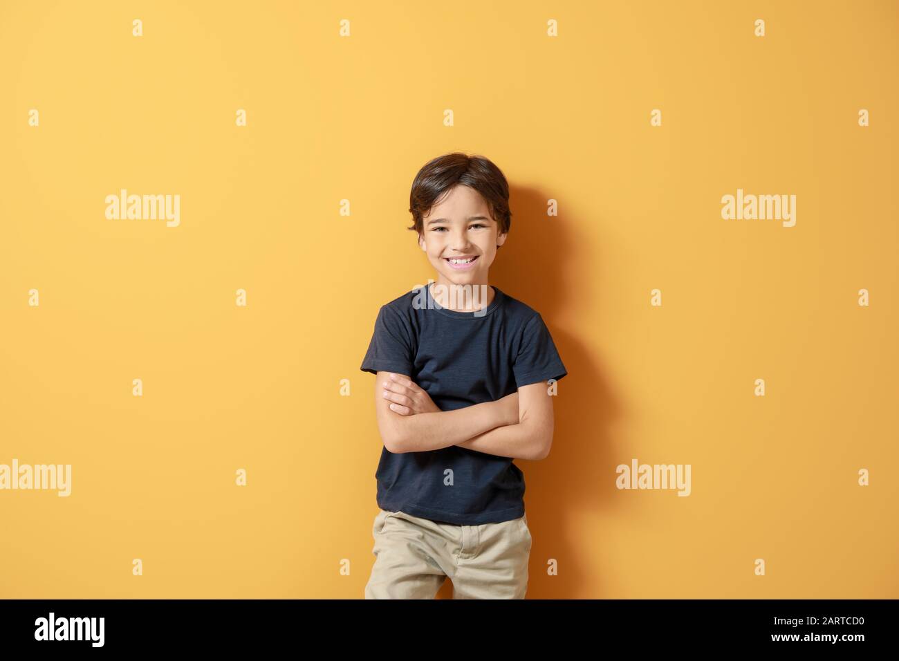 Cute little boy on color background Stock Photo - Alamy