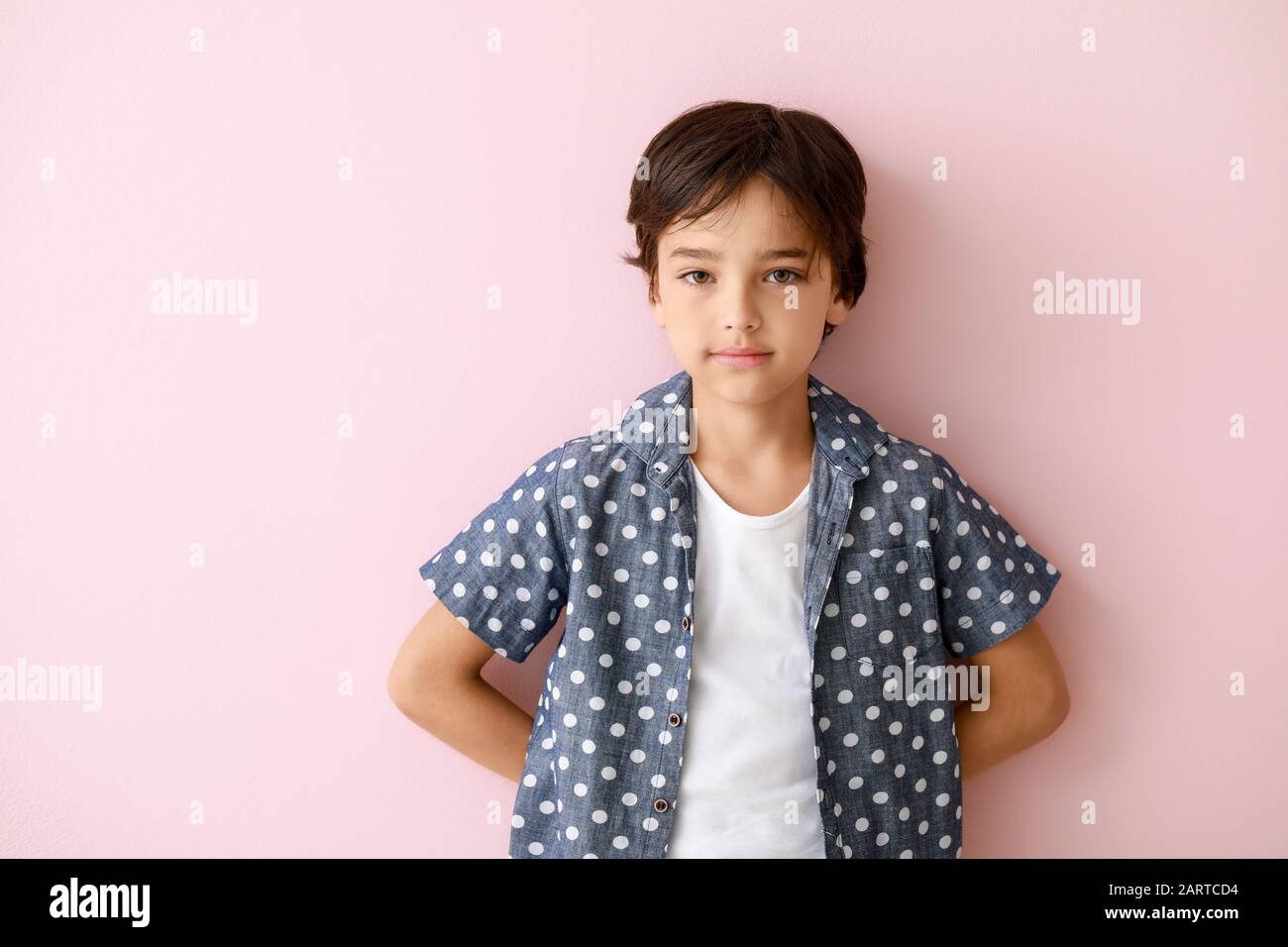 Cute little boy on color background Stock Photo - Alamy