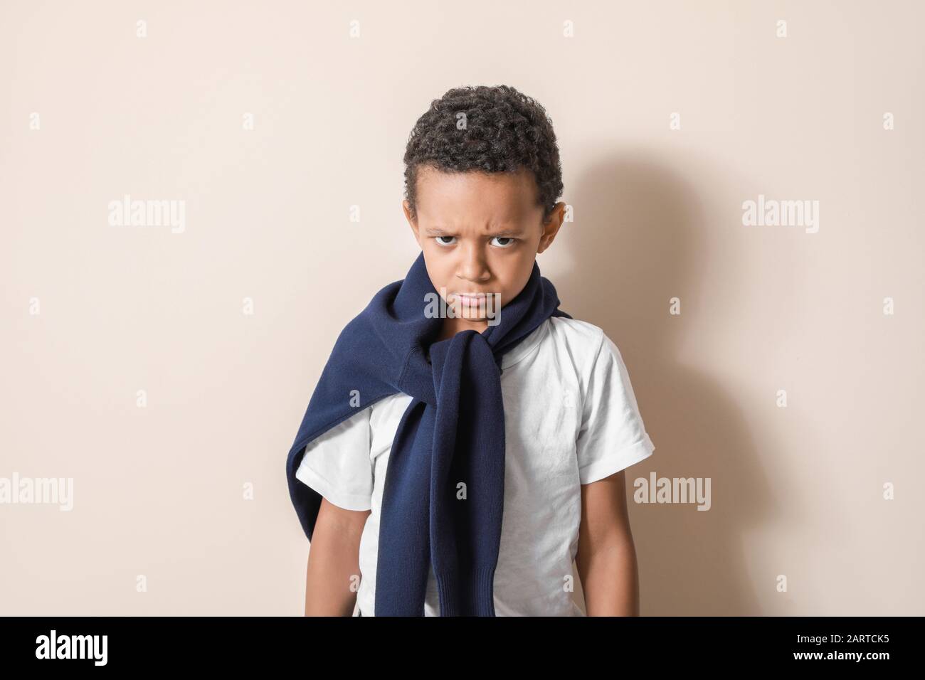 Angry African-American boy on light background Stock Photo - Alamy