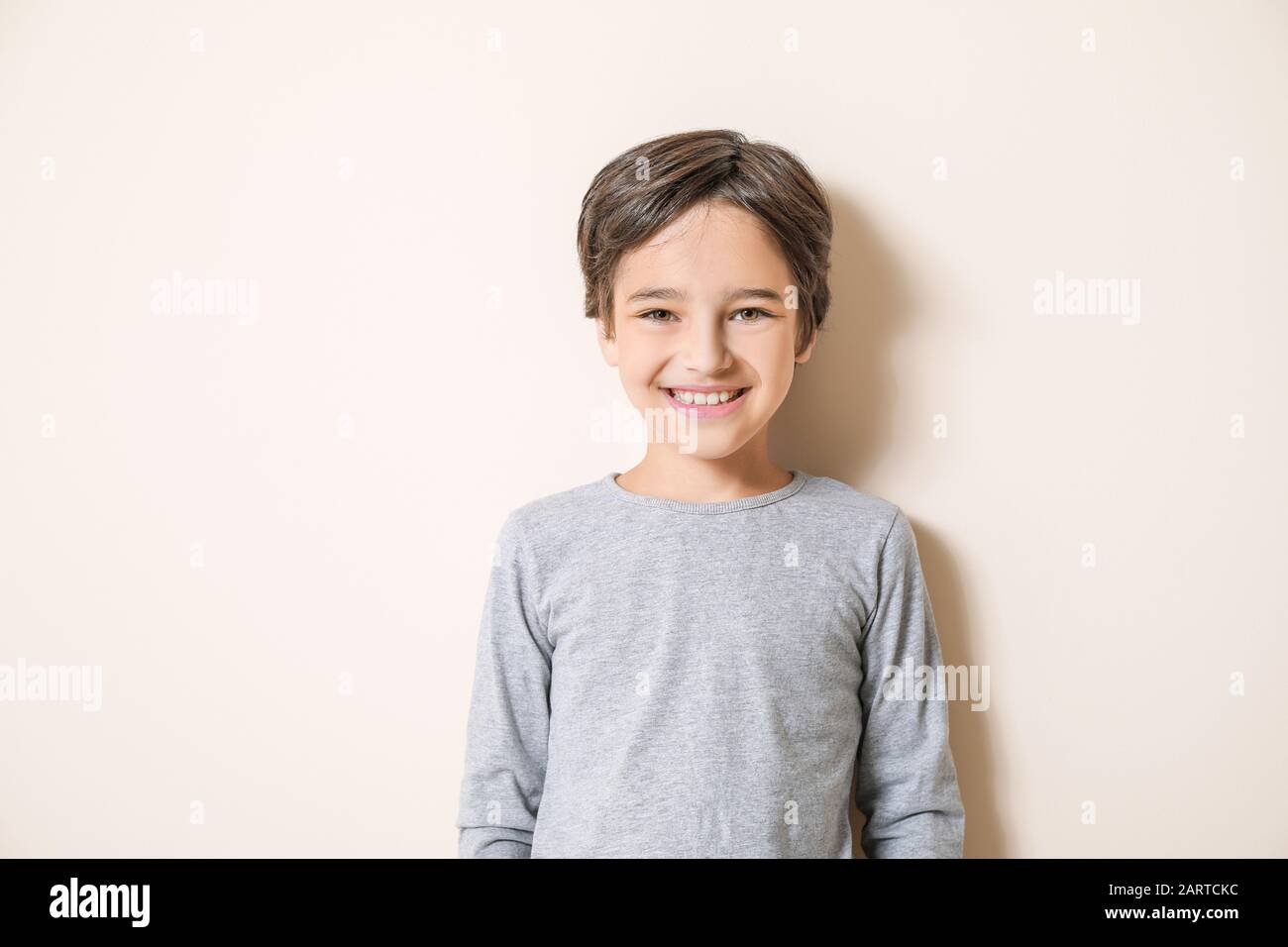 Cute little boy on light background Stock Photo - Alamy
