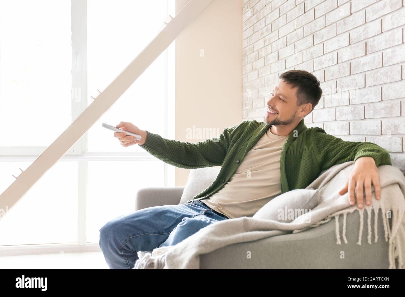 Happy man watching TV at home Stock Photo - Alamy