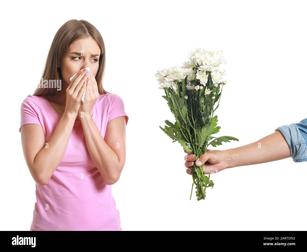 Man giving flowers to young woman suffering from allergy on white ...