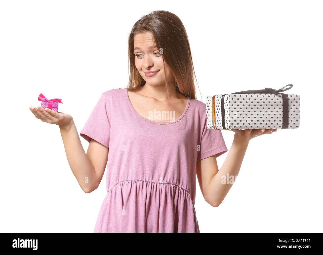 Confused woman with gift boxes on white background Stock Photo - Alamy