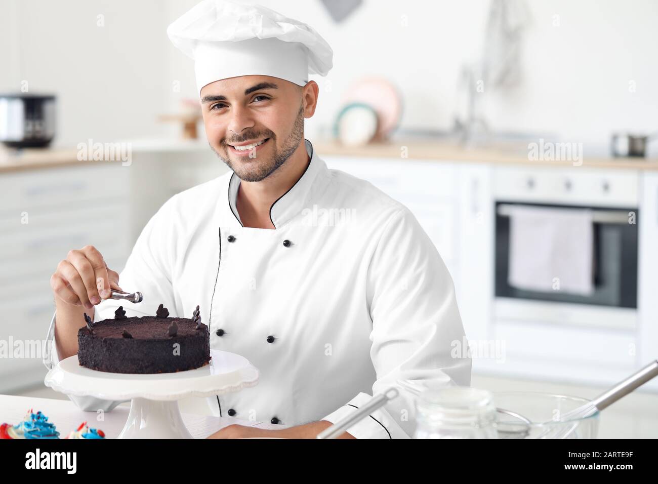 Male confectioner decorating tasty hi-res stock photography and images ...