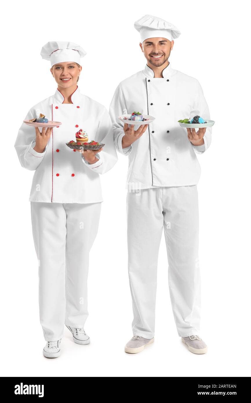 Young confectioners with tasty desserts on white background Stock Photo ...