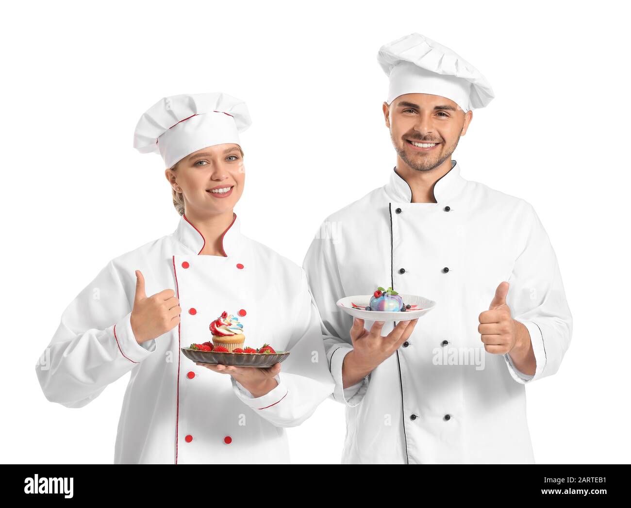 Young confectioners with tasty desserts showing thumb-up gesture on ...