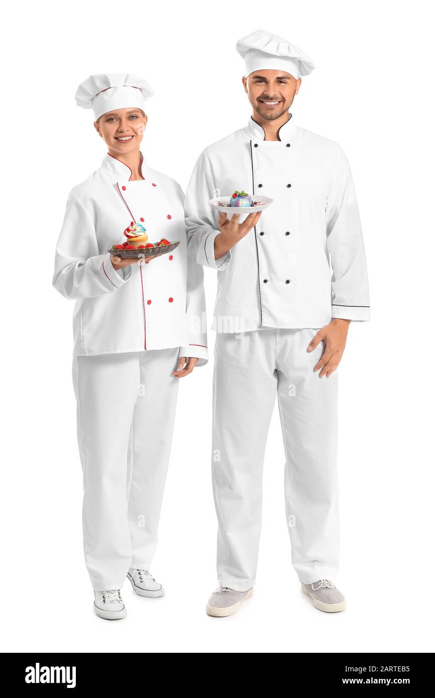 Young confectioners with tasty desserts on white background Stock Photo ...