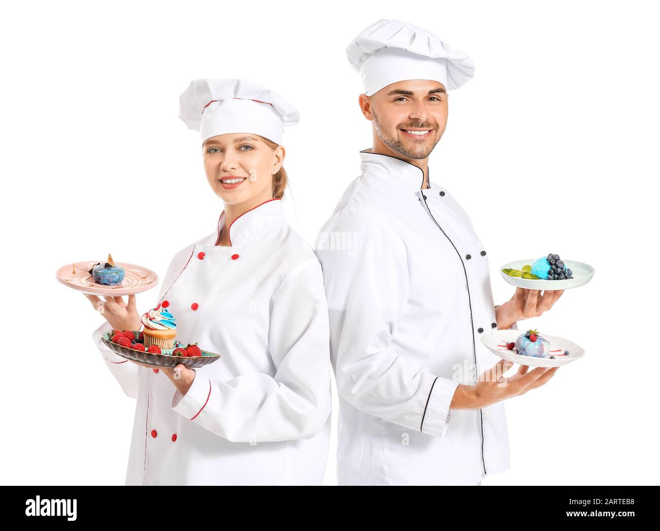 Young confectioners with tasty desserts on white background Stock Photo ...