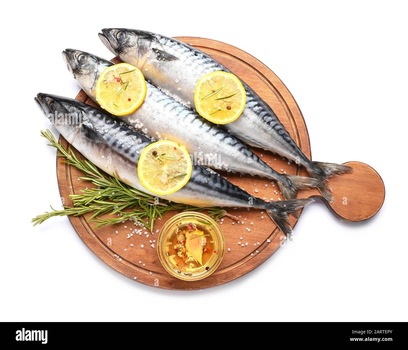 Board with raw mackerel fish and spices on white background Stock Photo ...