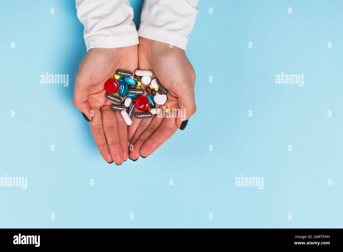 Woman holding a lot of different tablets and pills in her hands Stock ...