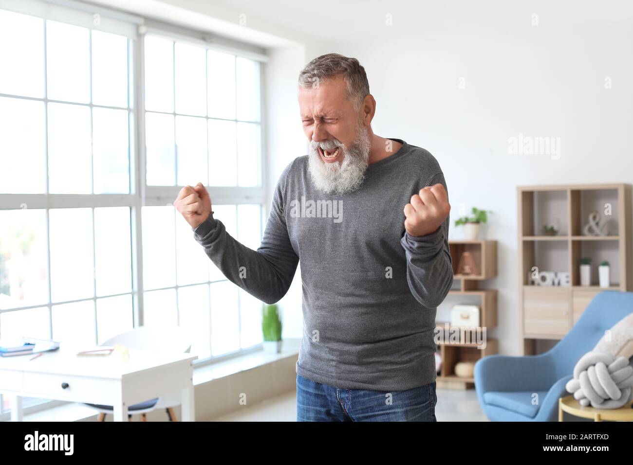 Angry mature man at home Stock Photo - Alamy