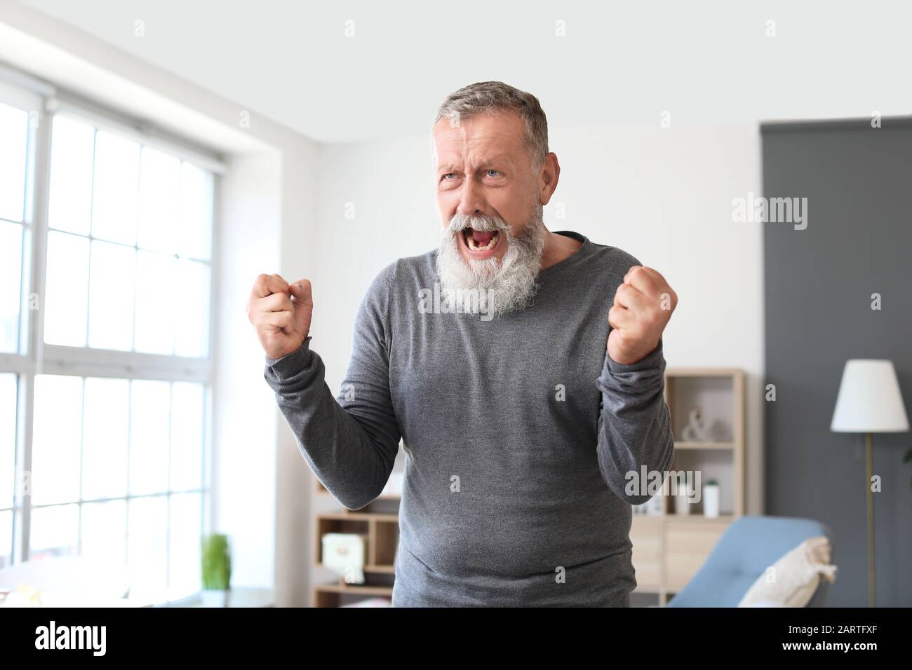 Angry mature man at home Stock Photo - Alamy