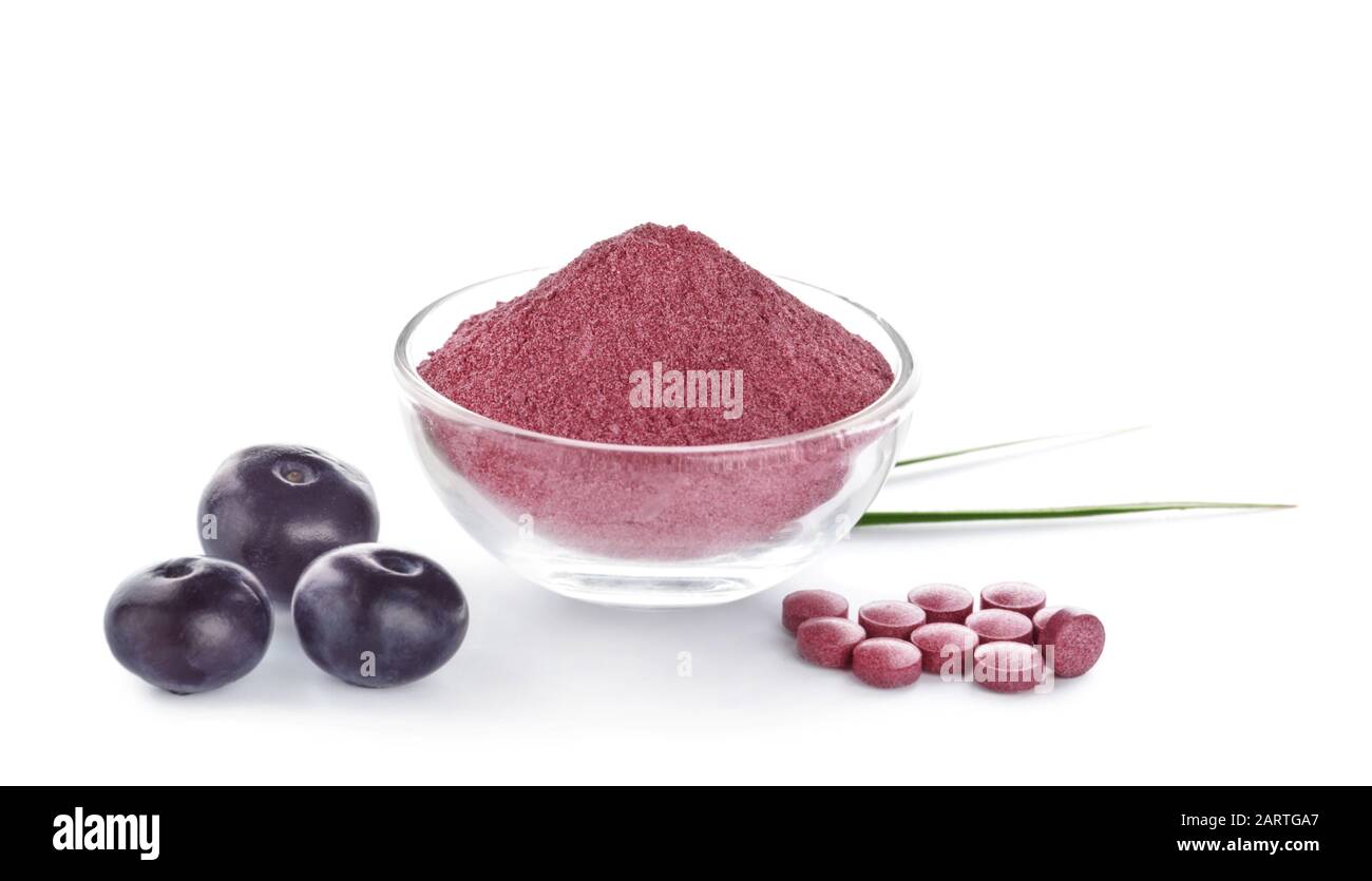 Bowl with acai powder and tablets on white background Stock Photo - Alamy