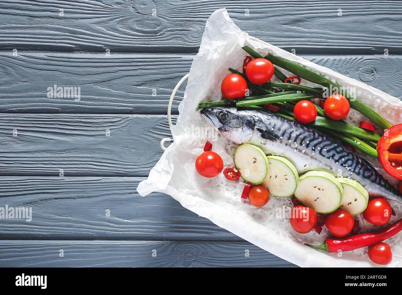 Tray with raw mackerel fish and vegetables on wooden table Stock Photo ...