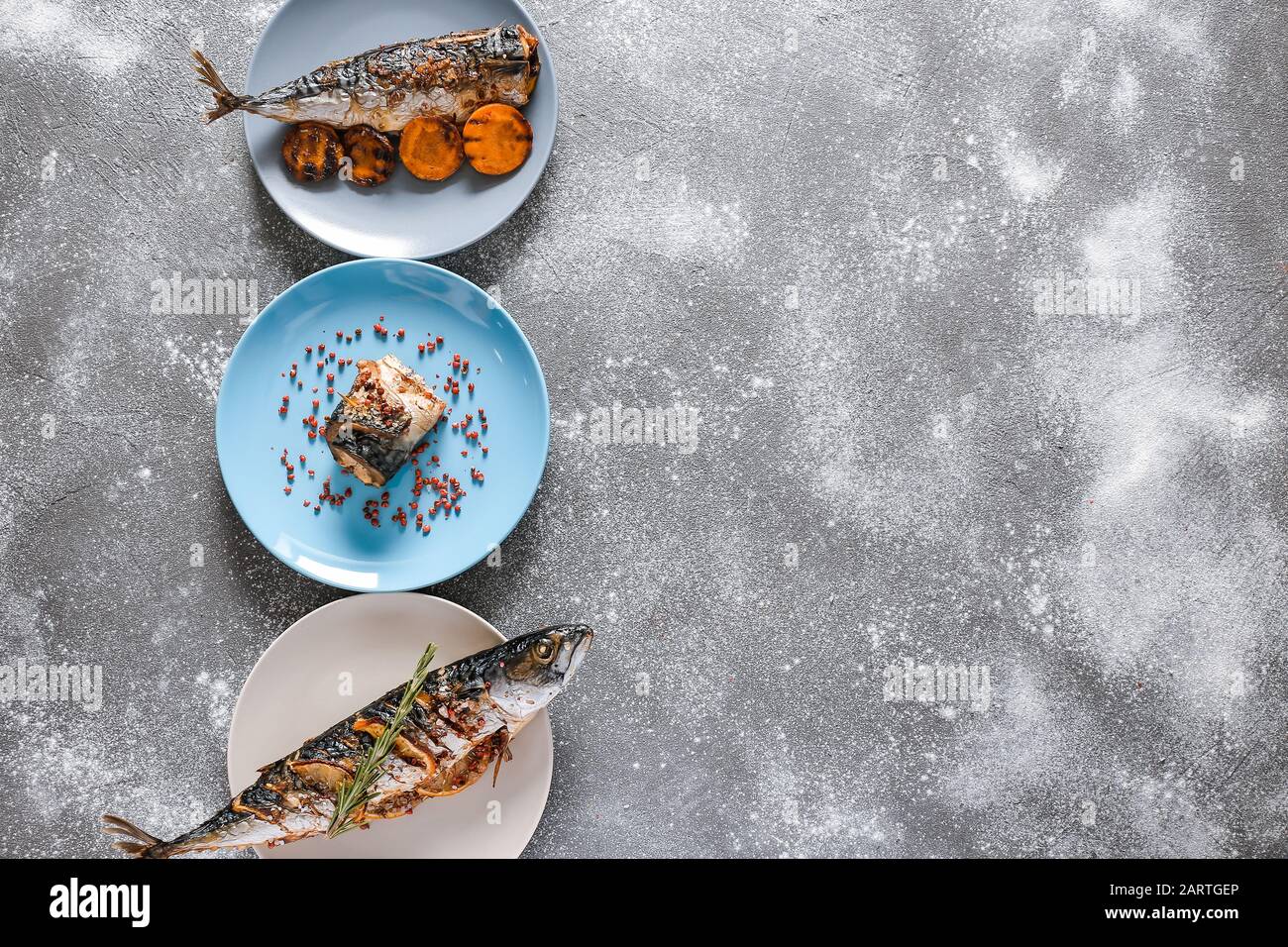 Plates with prepared mackerel fish on grey background Stock Photo - Alamy