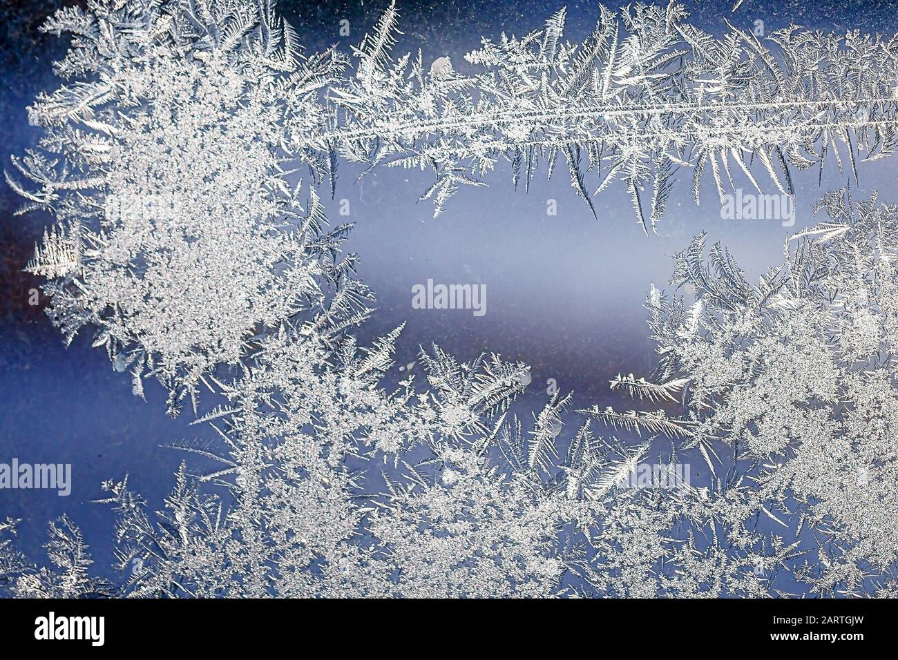 Frosty natural pattern on winter window, ornamental frost on the glass ...