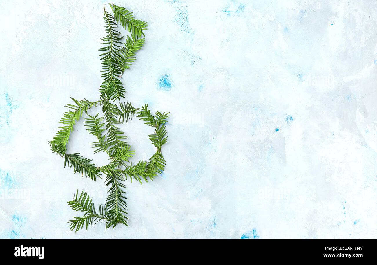 Treble clef made of fir tree branches on color background Stock Photo ...