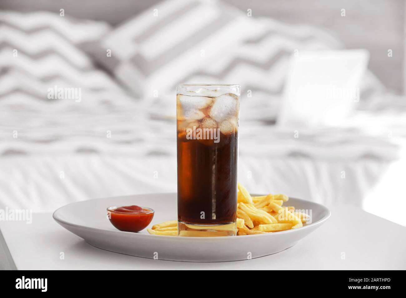 Glass of cold cola with french fries on table in room Stock Photo - Alamy