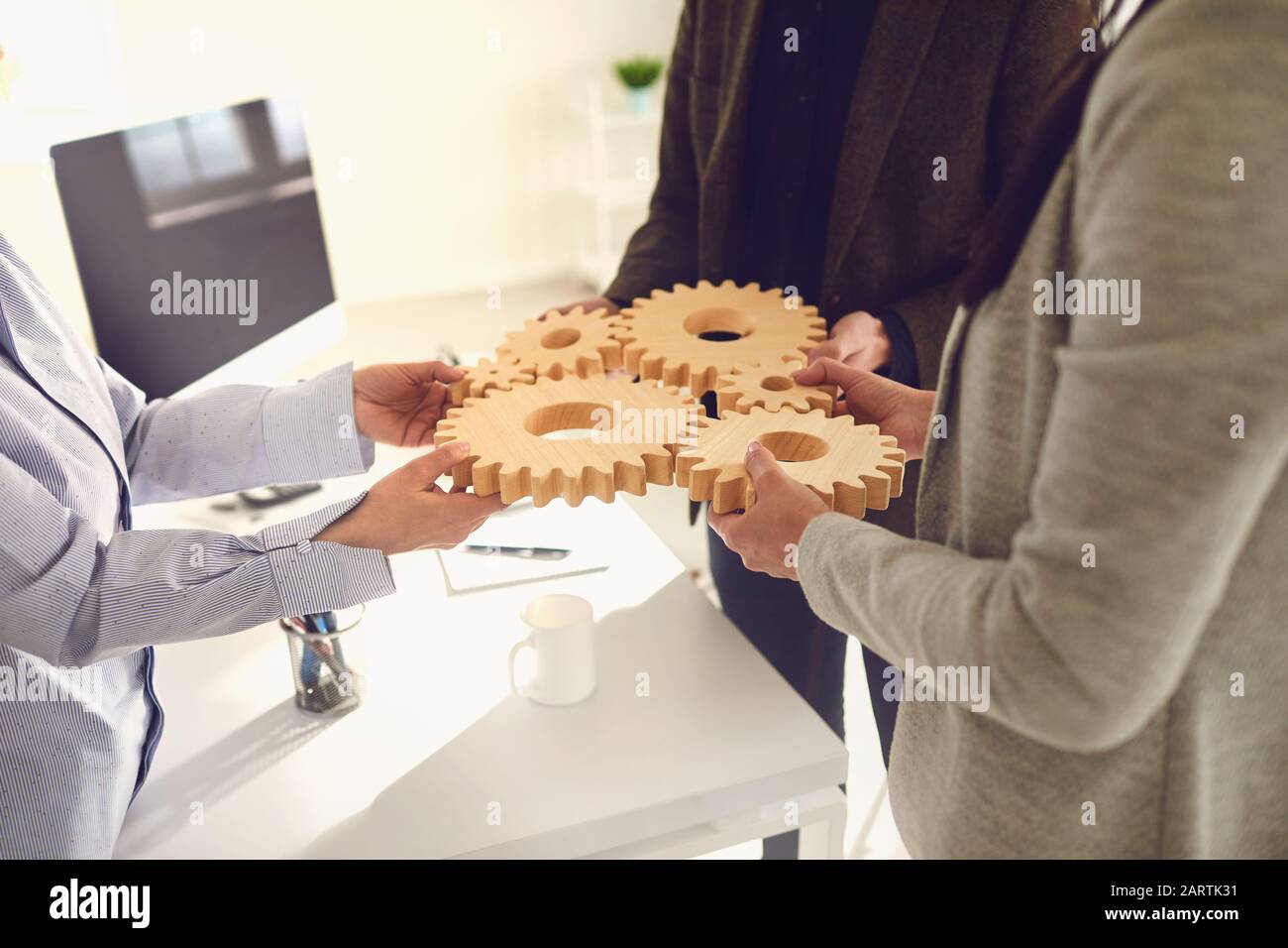 Team of business people connect gears during a business meeting in the ...