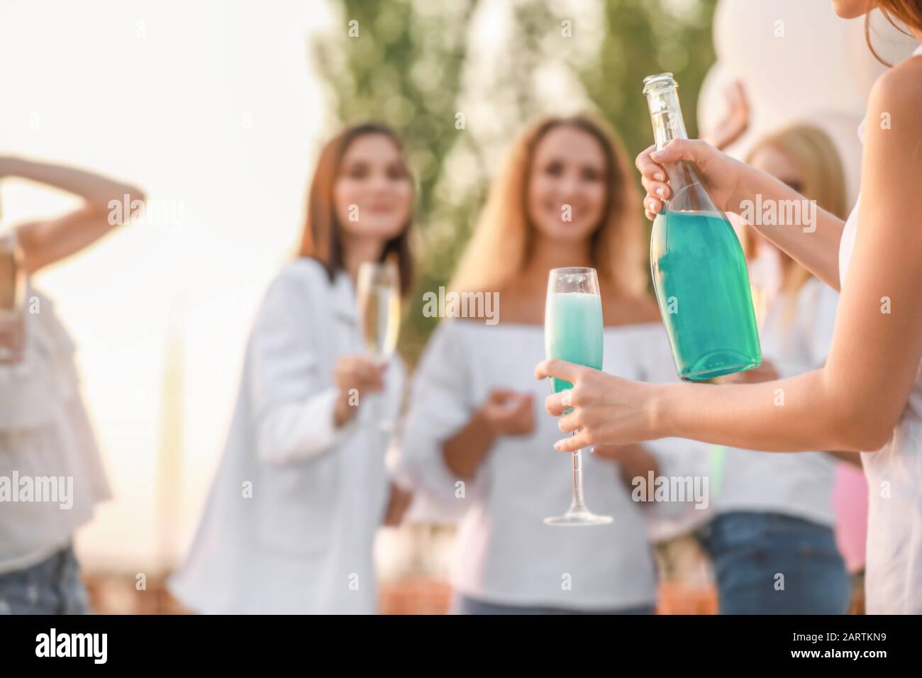 Beautiful young women drinking champagne at hen party outdoors Stock ...