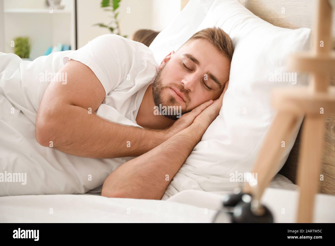 Morning of young man sleeping in bed Stock Photo - Alamy