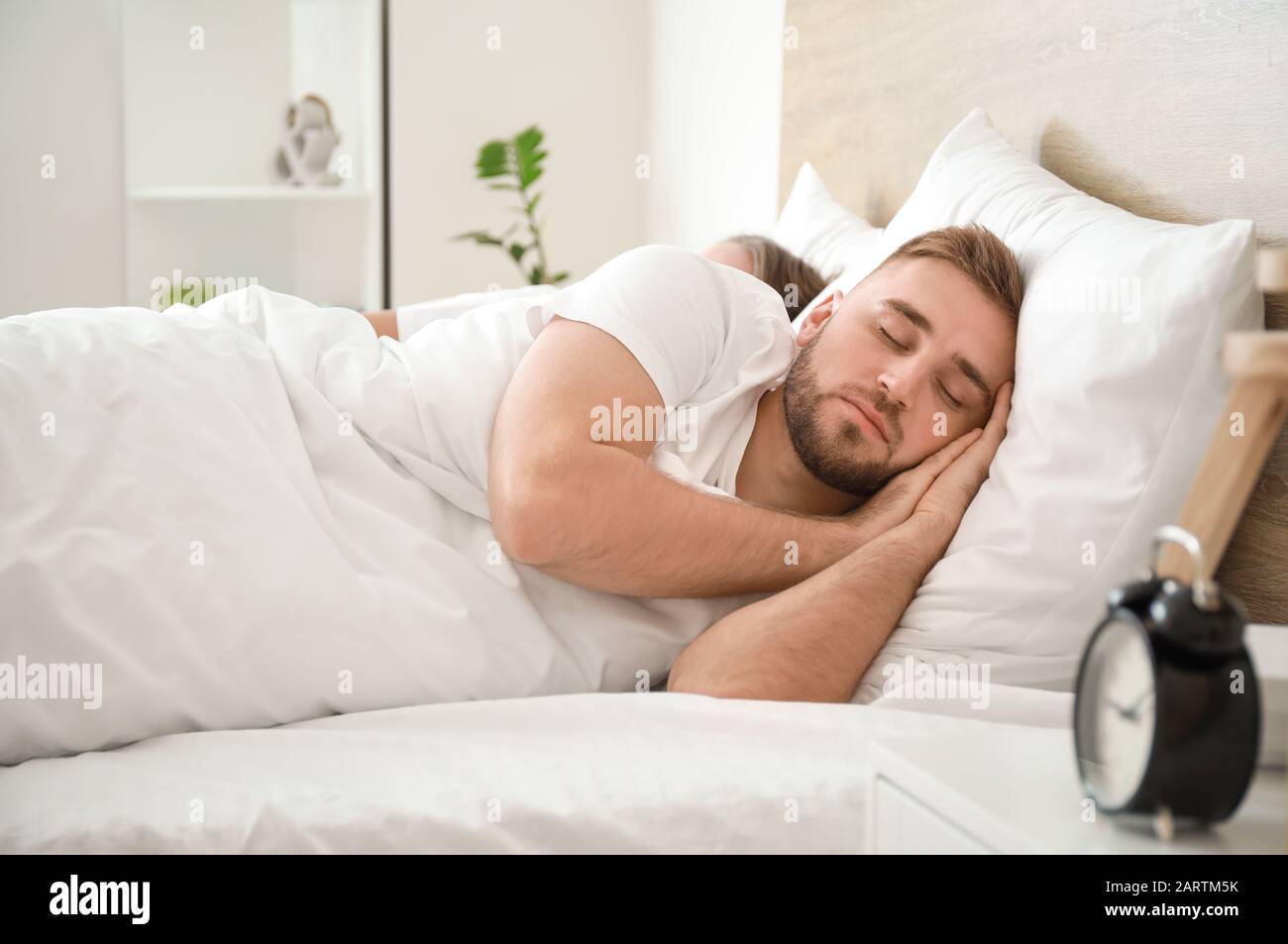 Morning of young man sleeping in bed Stock Photo - Alamy