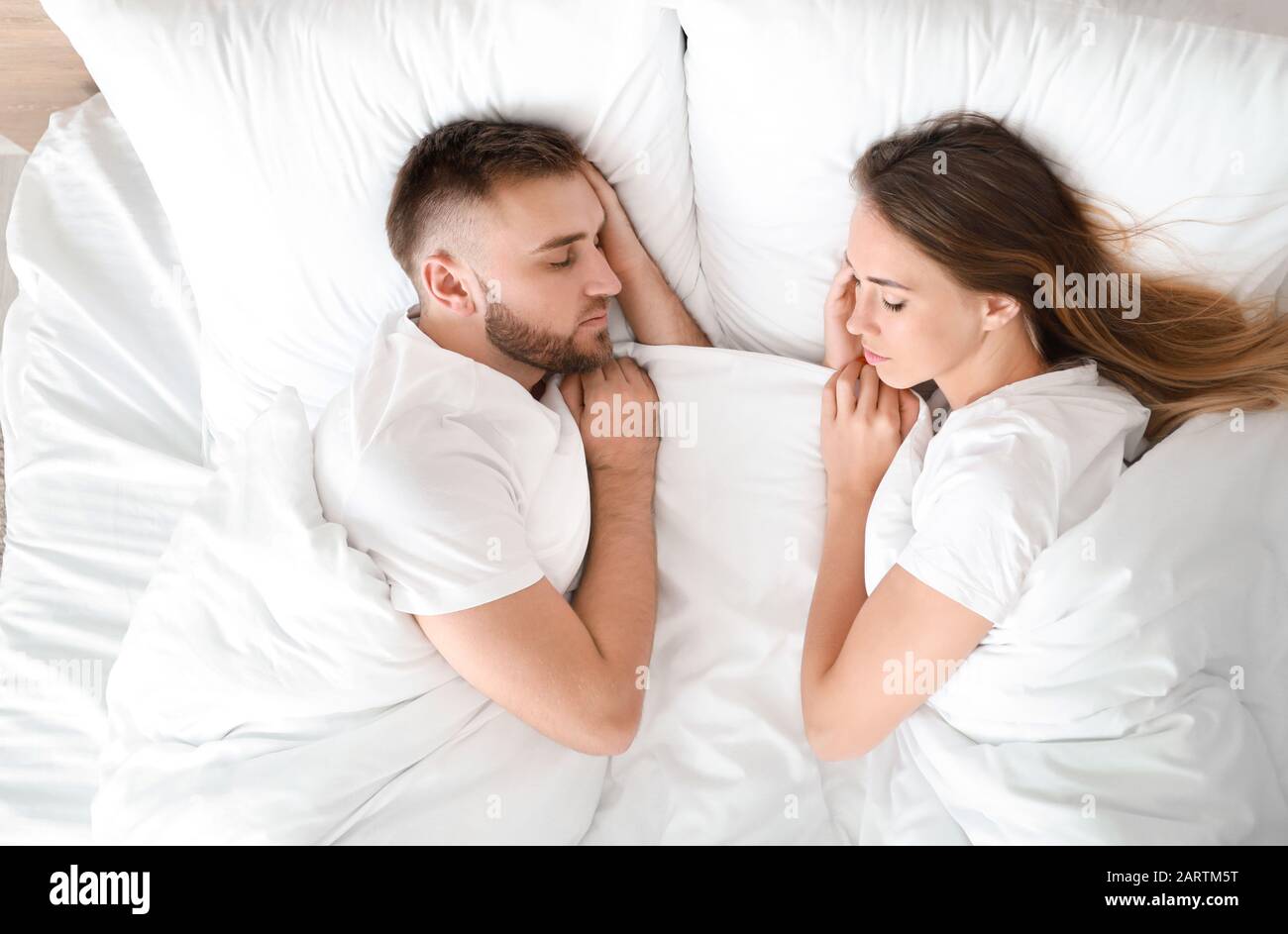 Morning of young couple sleeping in bed Stock Photo - Alamy