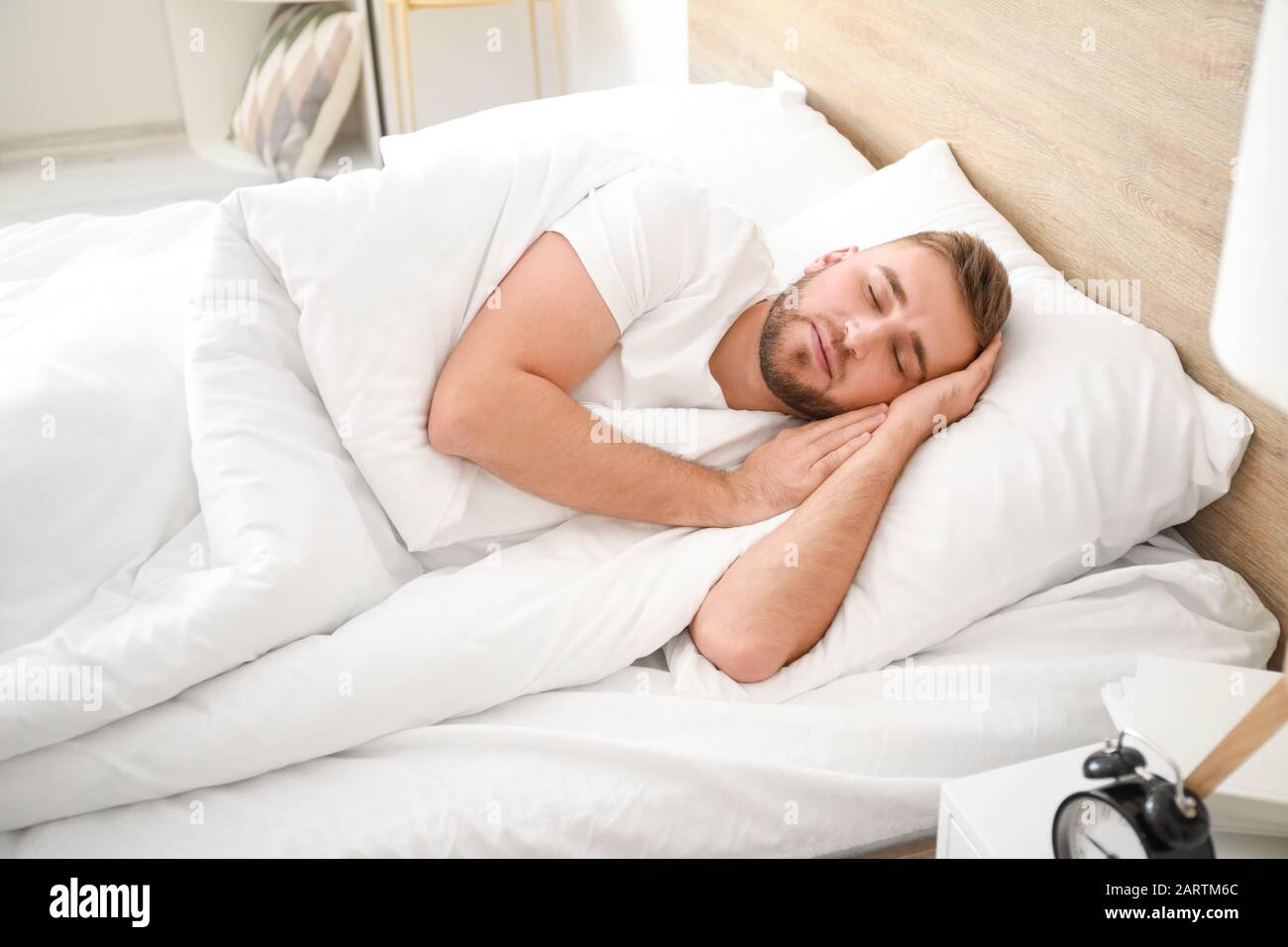 Morning of young man sleeping in bed Stock Photo - Alamy
