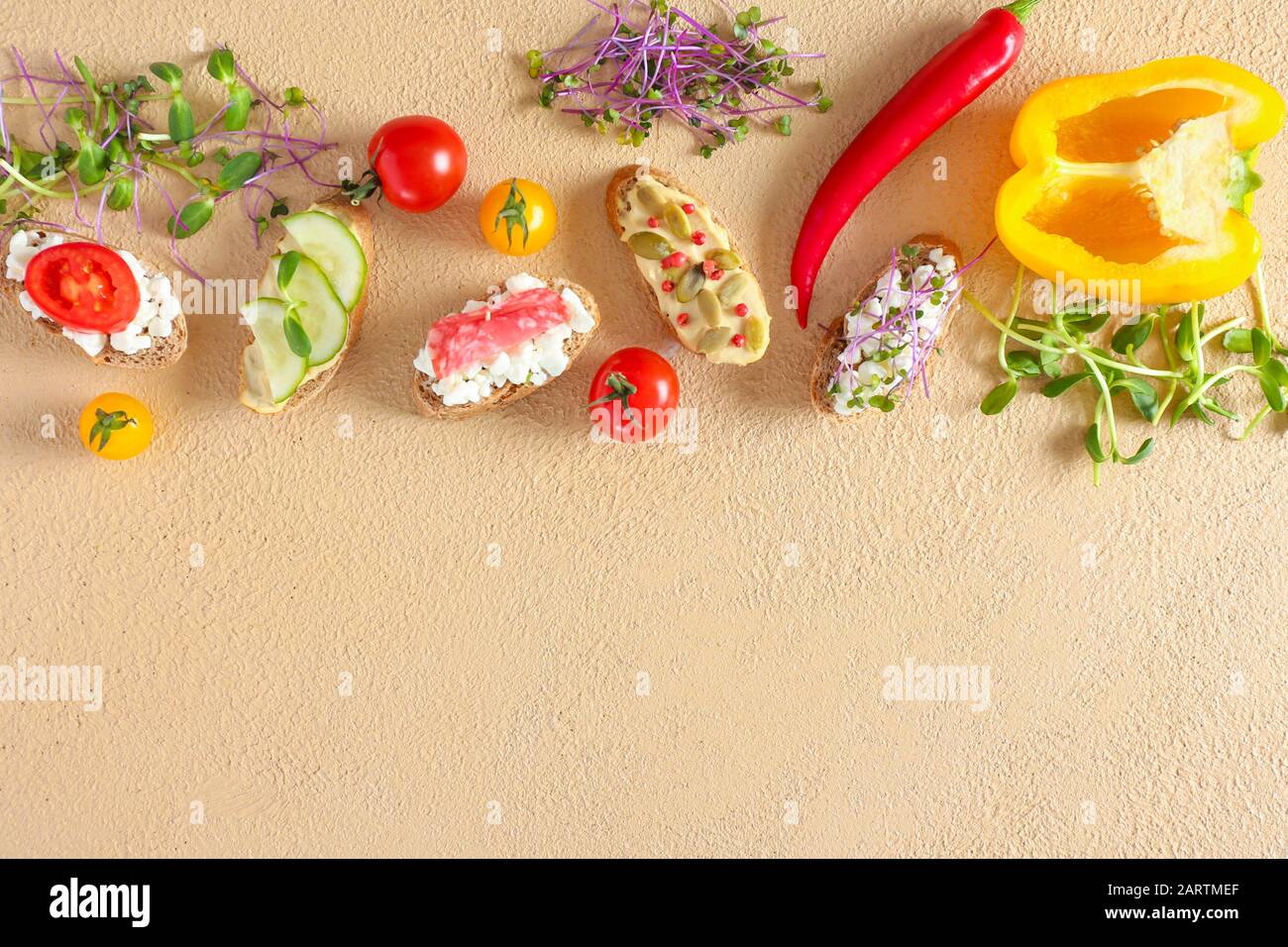 Different tasty sandwiches on color background Stock Photo - Alamy