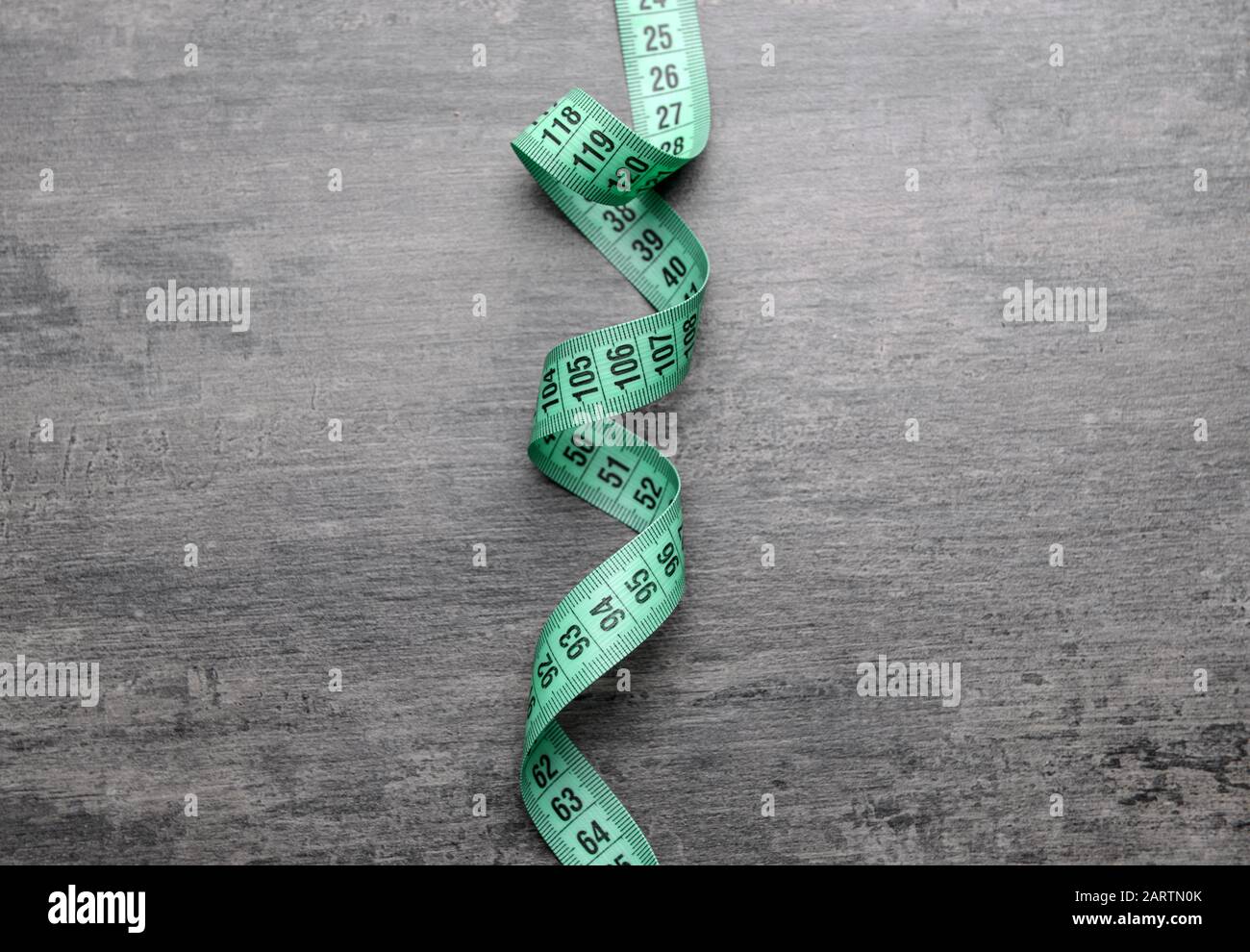 Measuring tape on grey background Stock Photo - Alamy