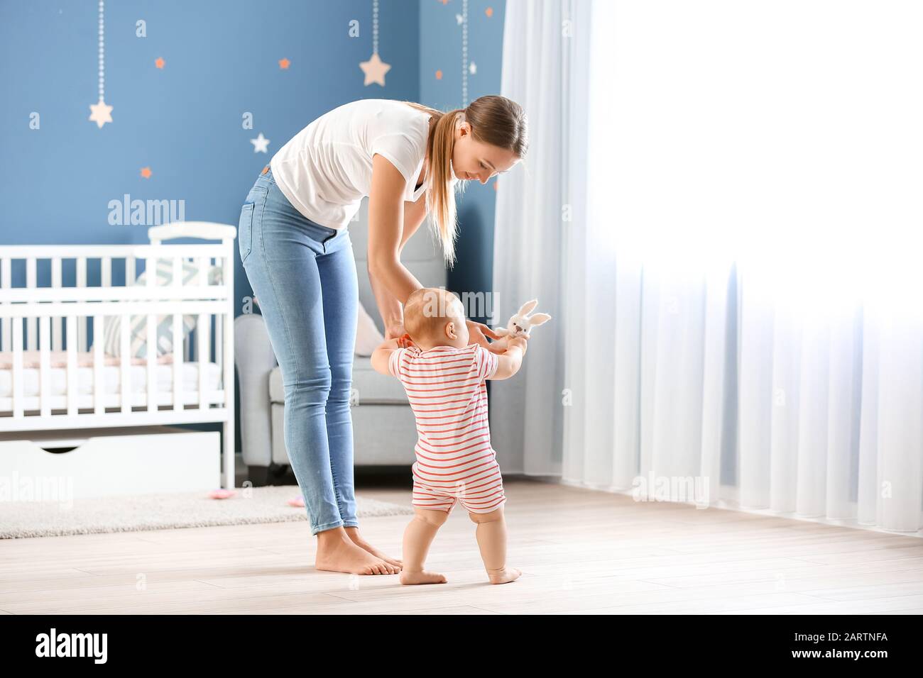Mother teaching her little baby to walk at home Stock Photo - Alamy
