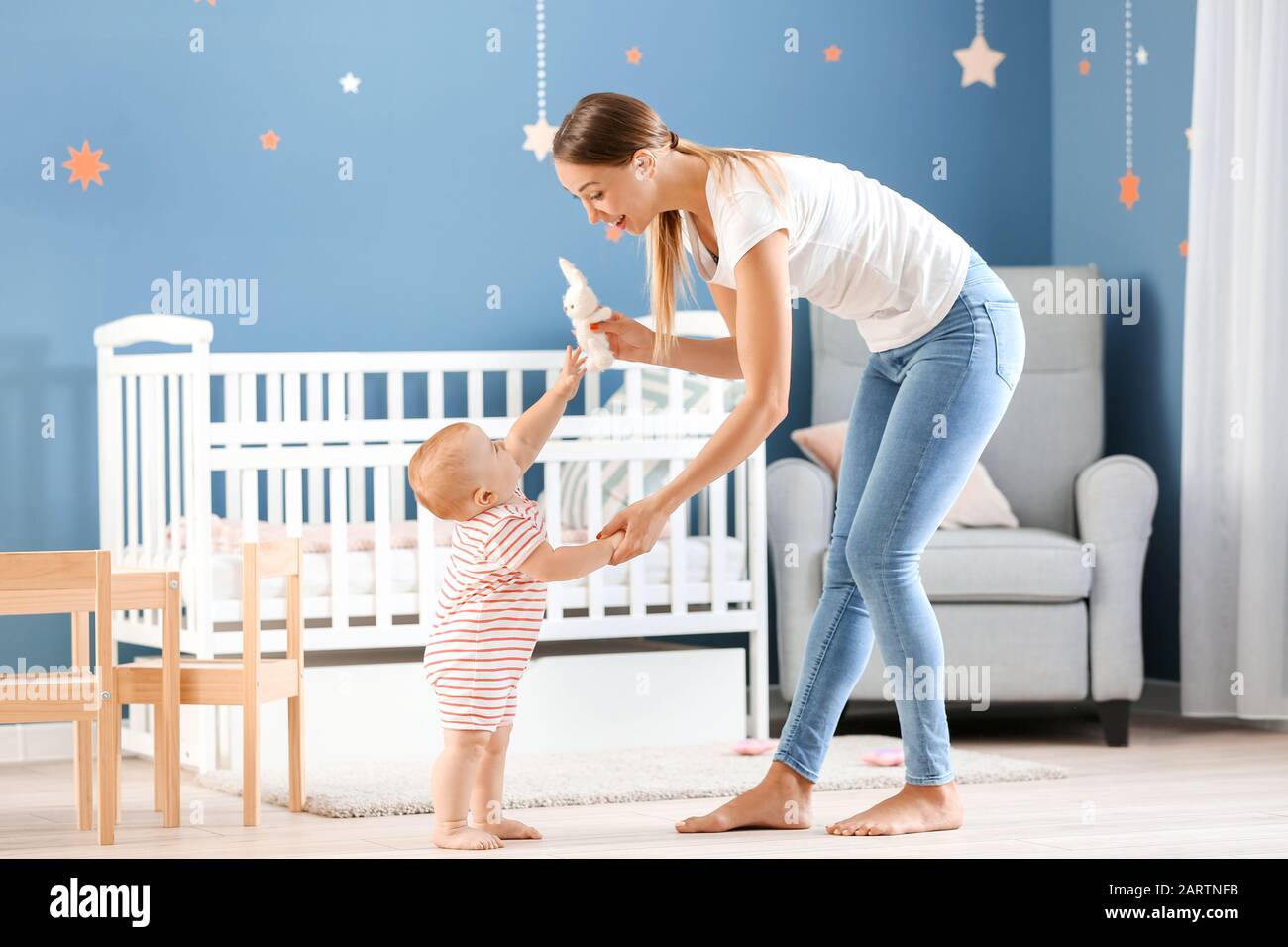 Mother teaching her little baby to walk at home Stock Photo - Alamy