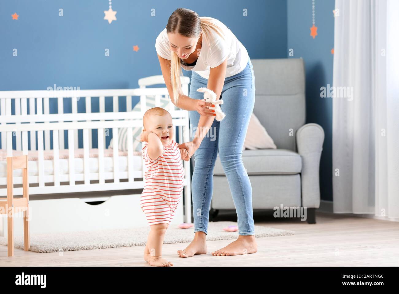 Mother teaching her little baby to walk at home Stock Photo - Alamy