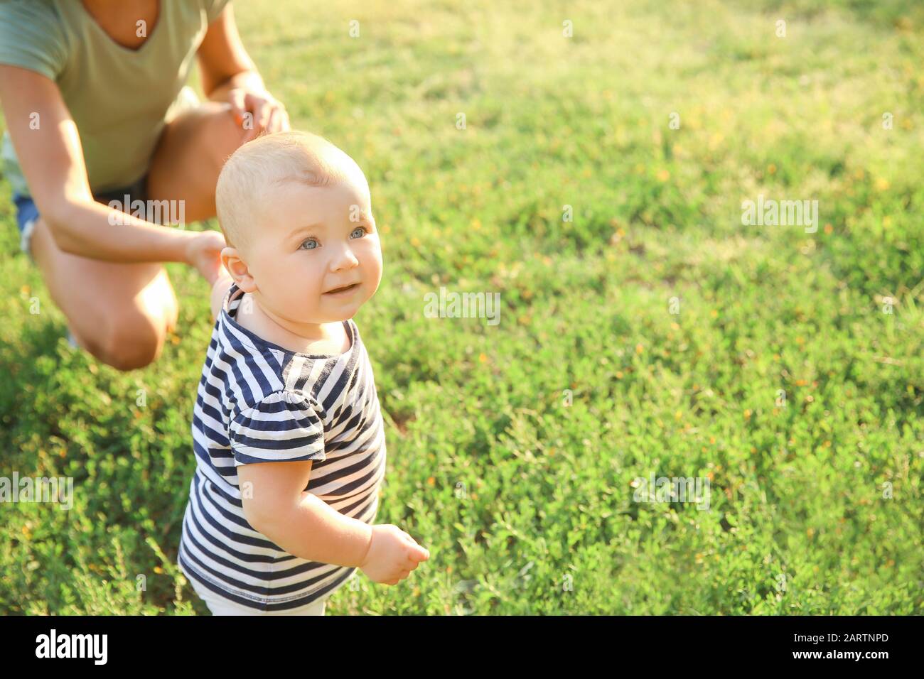 Mother teaching her little baby to walk outdoors Stock Photo - Alamy