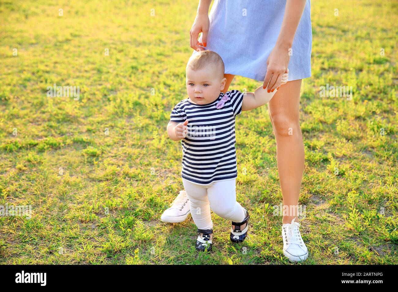 Mother teaching her little baby to walk outdoors Stock Photo - Alamy