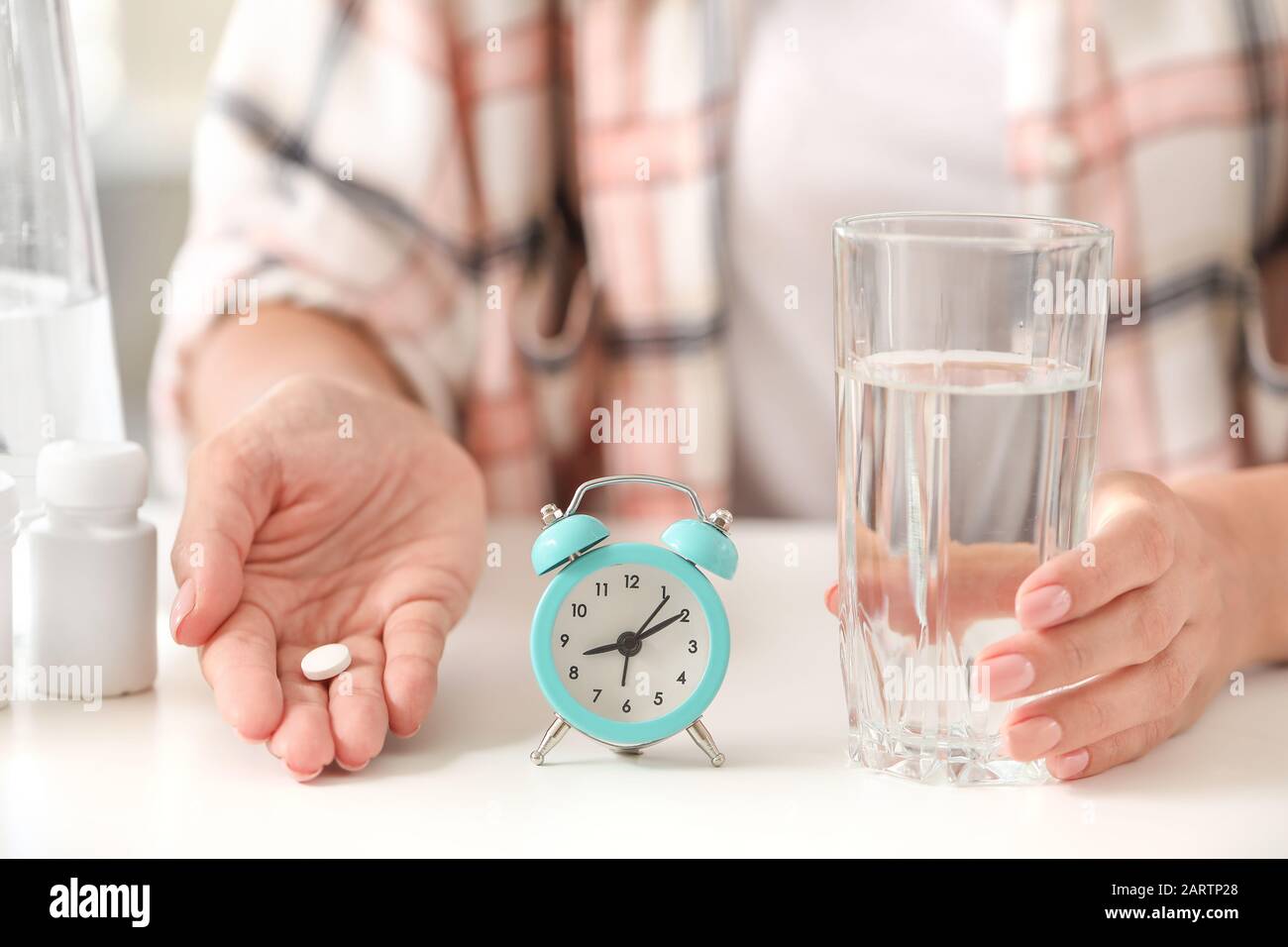 Young woman taking pill at home, closeup Stock Photo - Alamy
