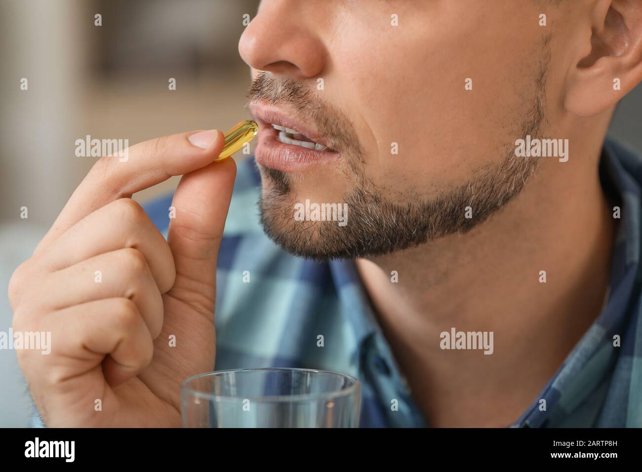 Man taking medicine at home, closeup Stock Photo - Alamy