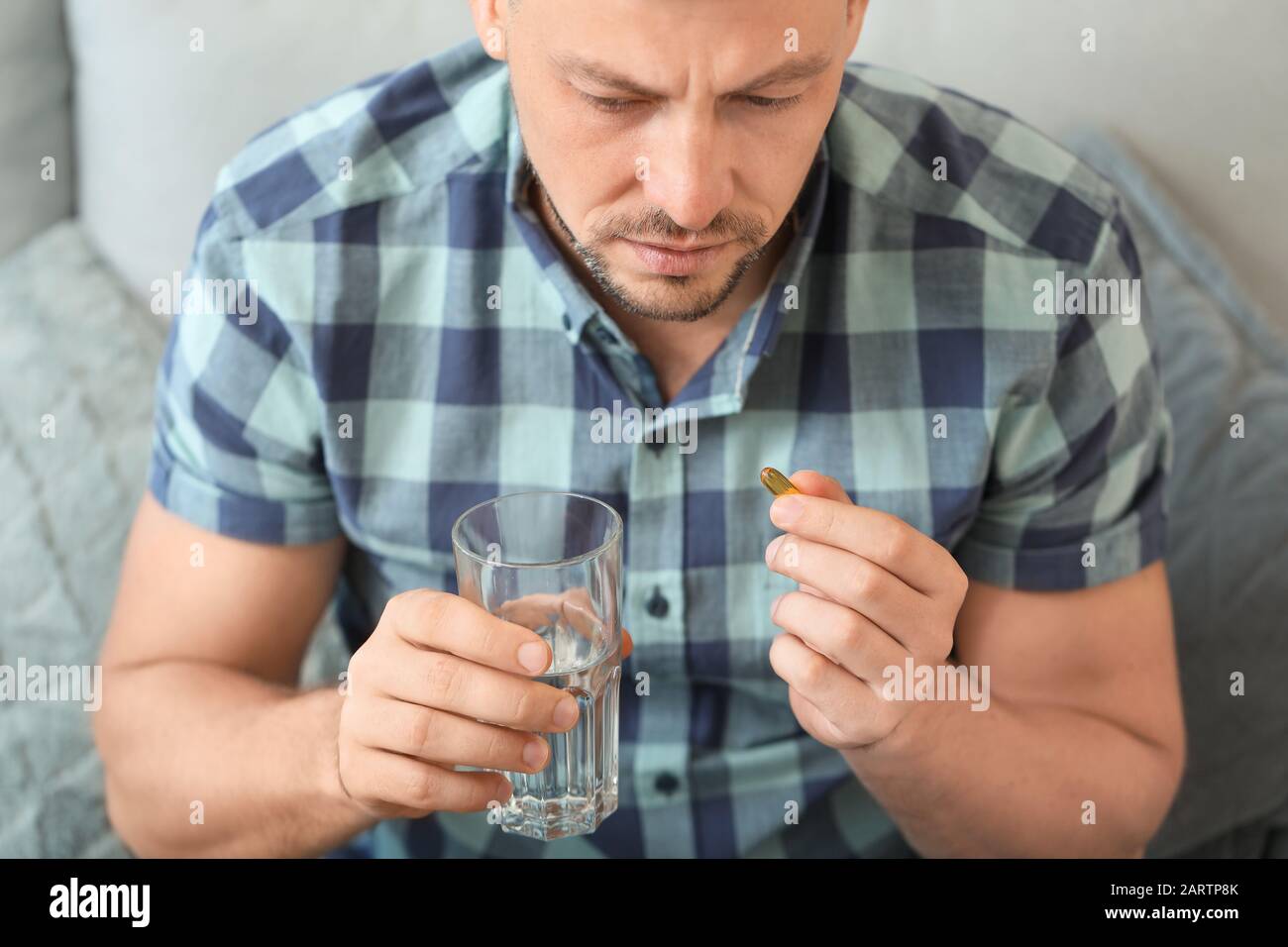 Man taking medicine at home Stock Photo - Alamy