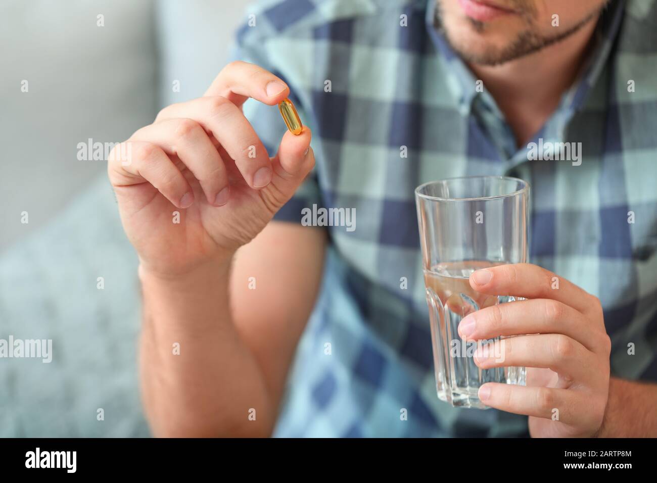 Man taking medicine at home, closeup Stock Photo - Alamy