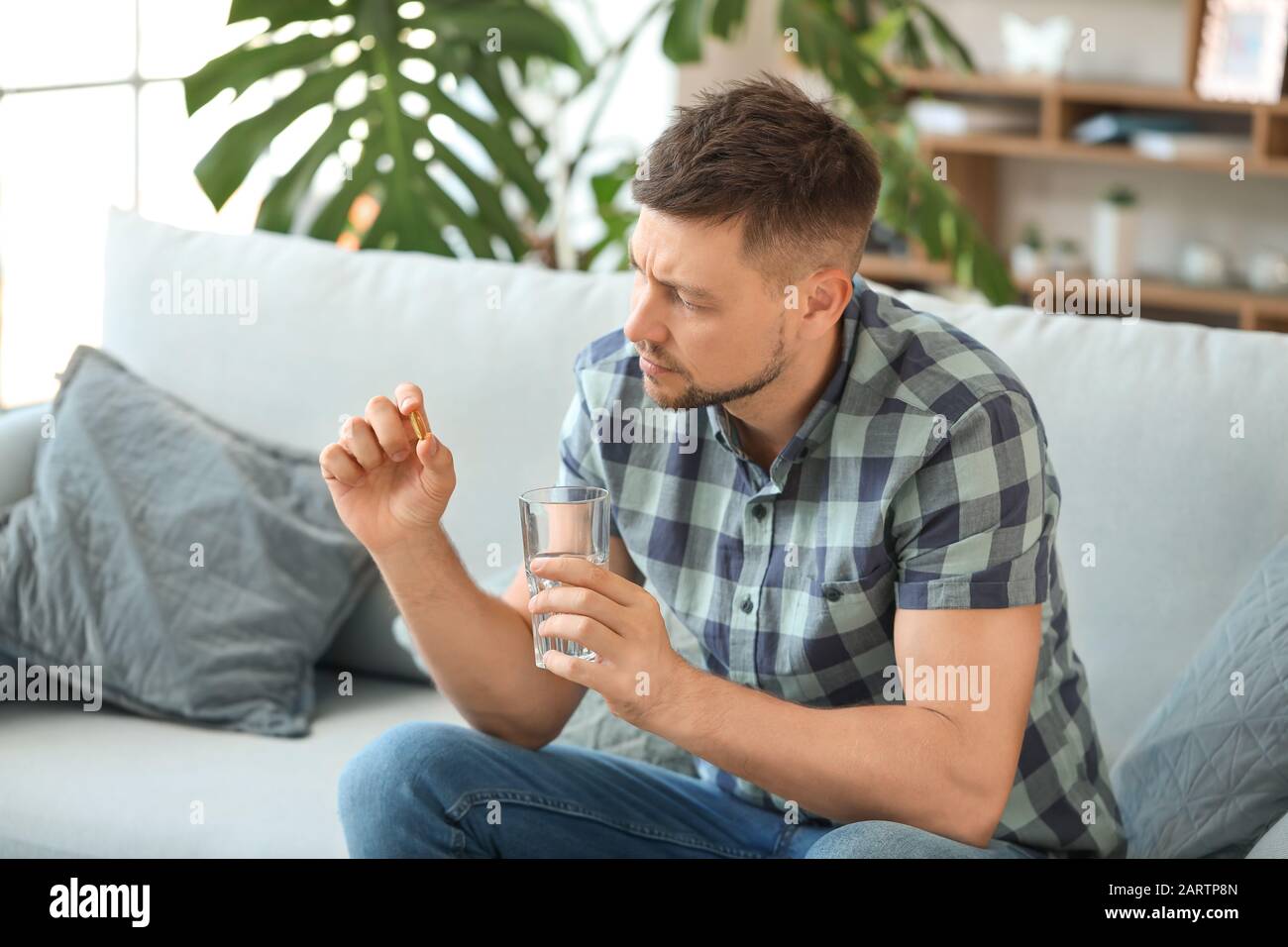 Man taking medicine at home Stock Photo - Alamy